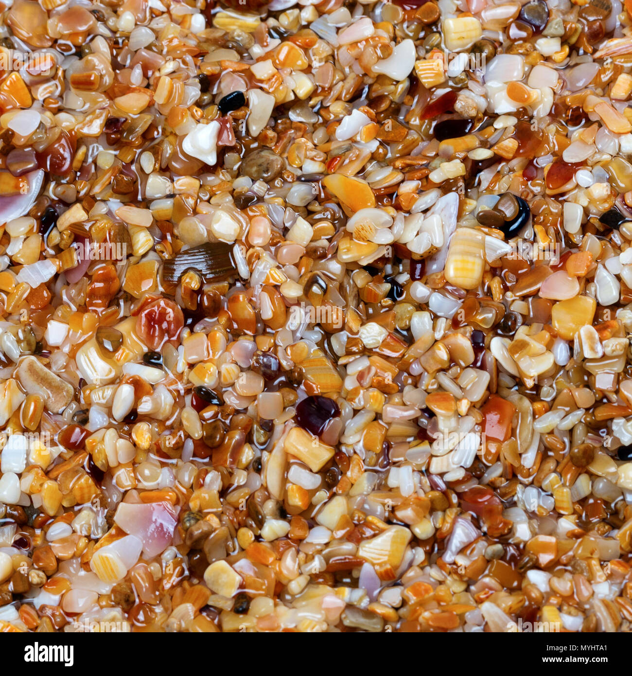Wet multicolor sand on beach in sun summer day. View from above. Nature ...