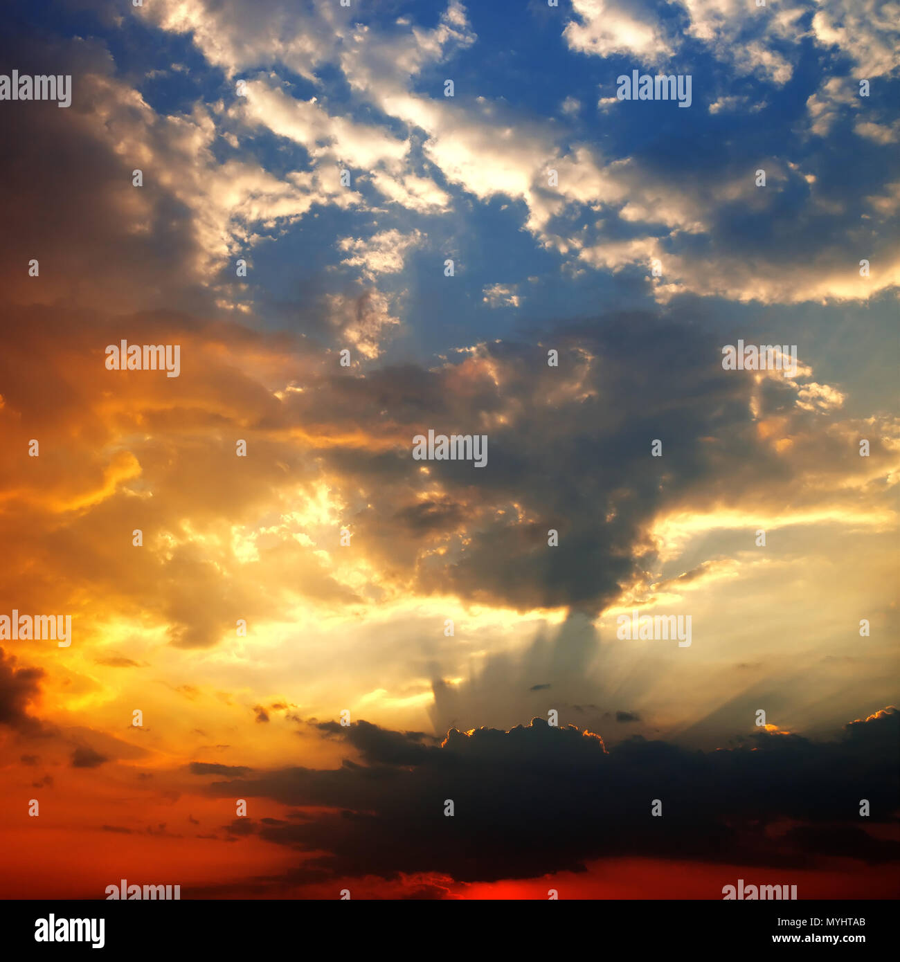 Beautiful multicolor sunset sky with clouds and sun rays above the sea ...