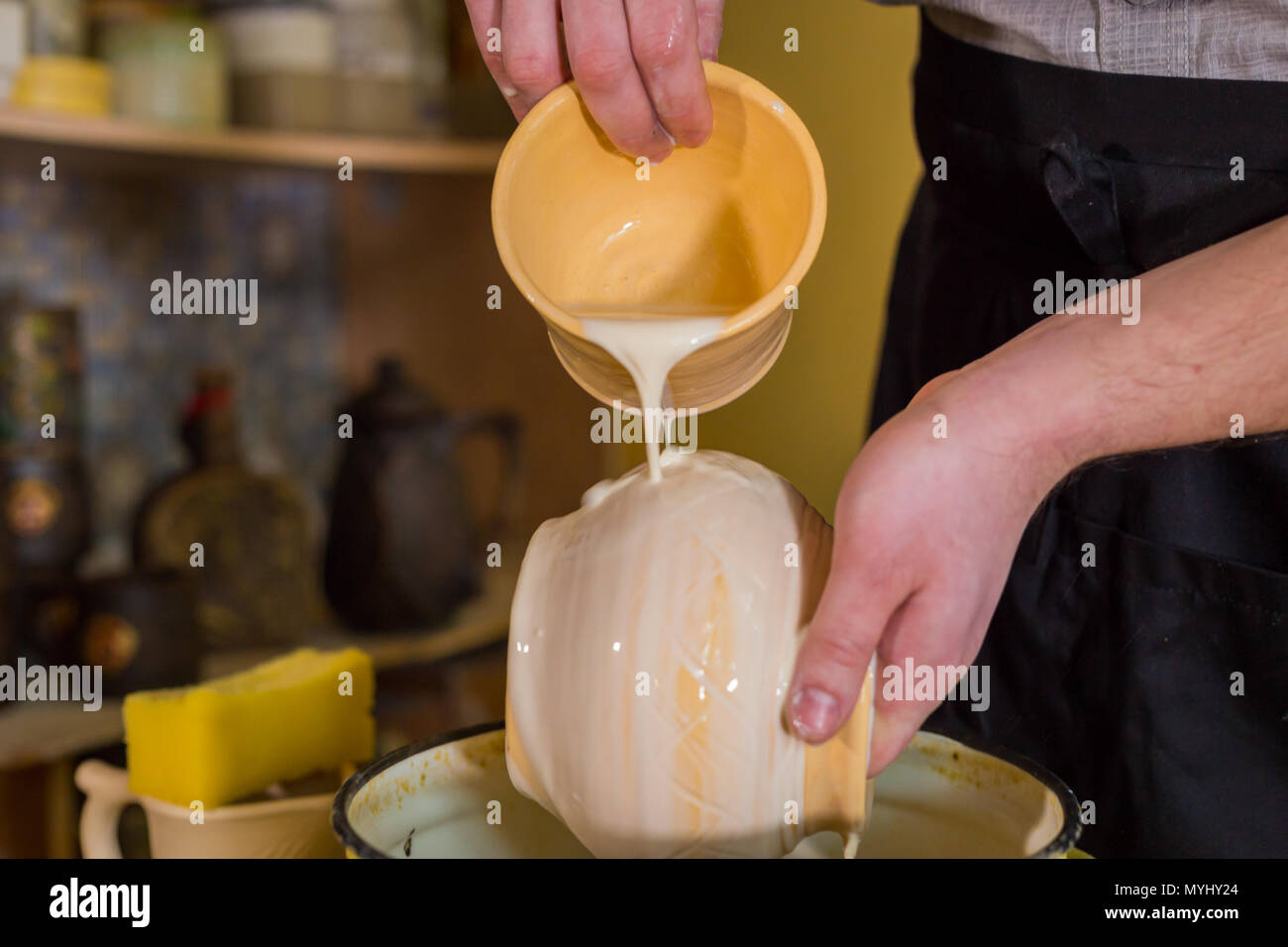 Professional male potter preparing ceramic wares for burning in pottery ...
