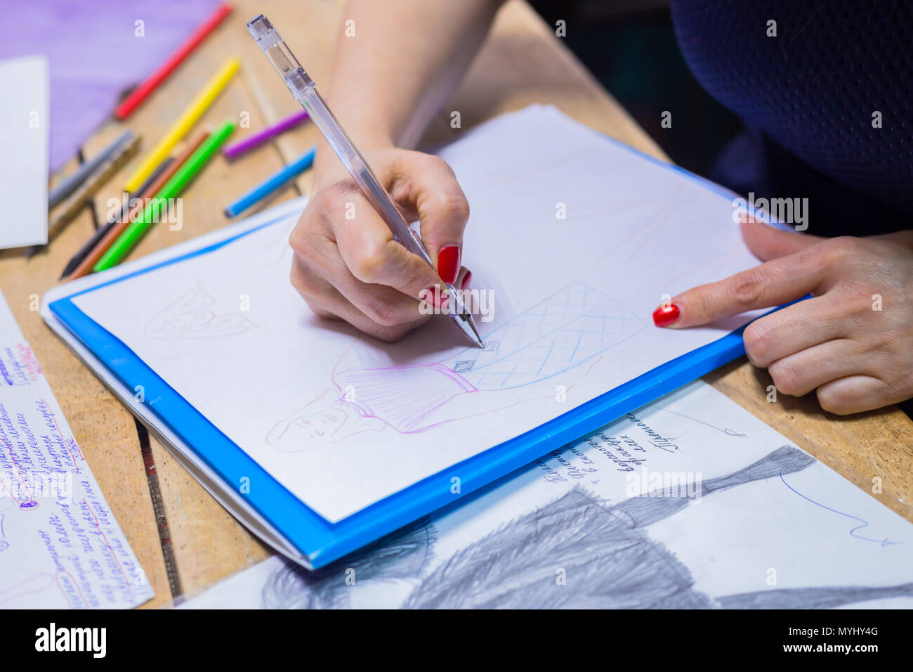 Close up shot - hands of professional tailor, designer drawing fashion ...