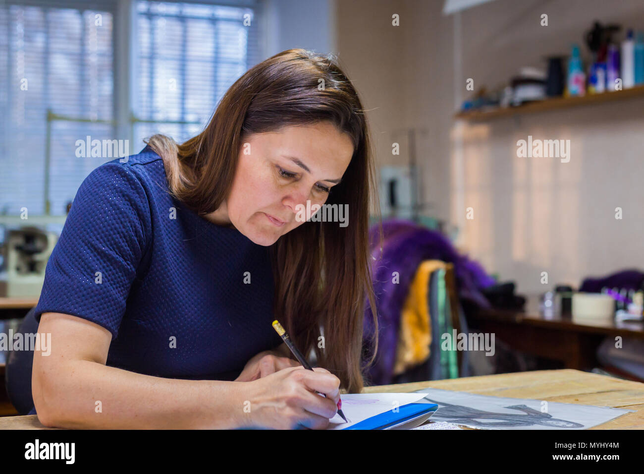 Professional tailor, designer drawing fashion sketch at atelier, studio ...