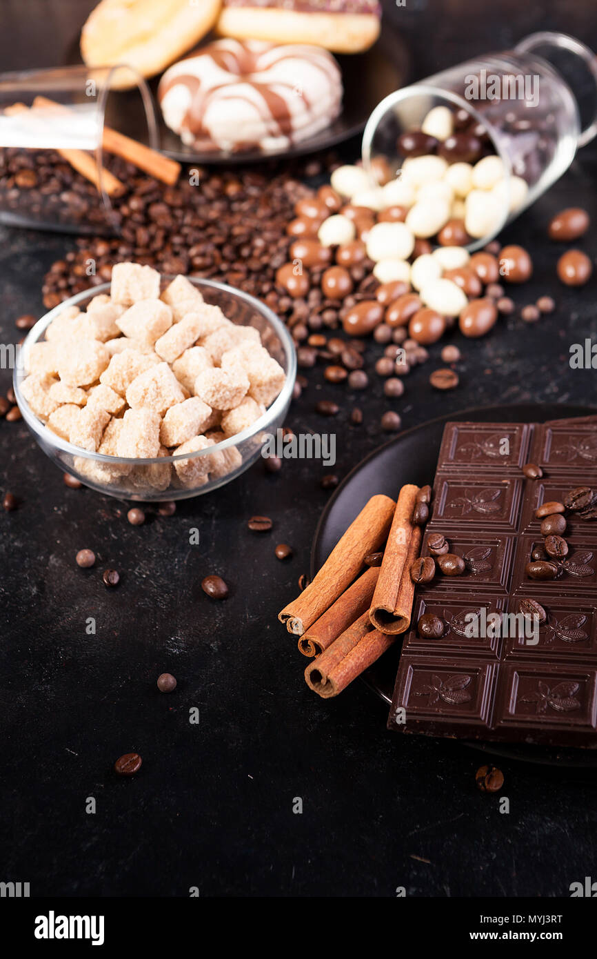 Chocolate tablets next to cinnamon rolls and other sweets and candies ...