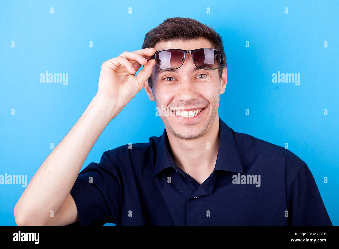 Smiling young man making silly faces Stock Photo - Alamy