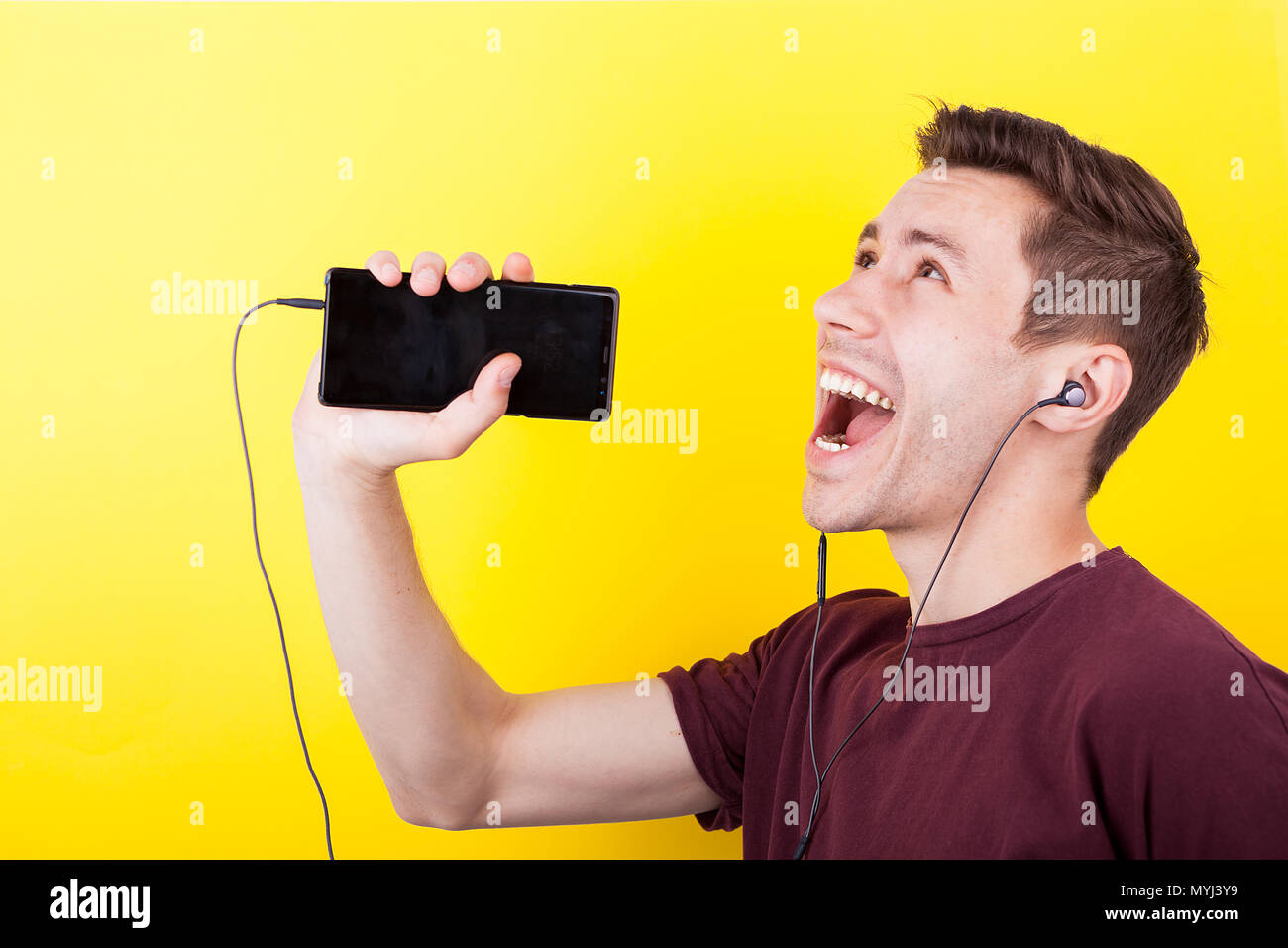 Man singing into phone hi-res stock photography and images - Alamy