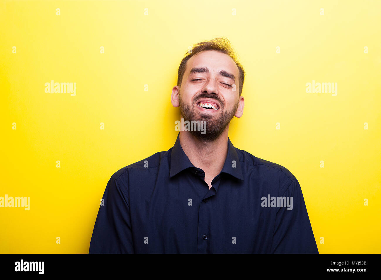 Happy joyful man smiling on yellow background Stock Photo - Alamy