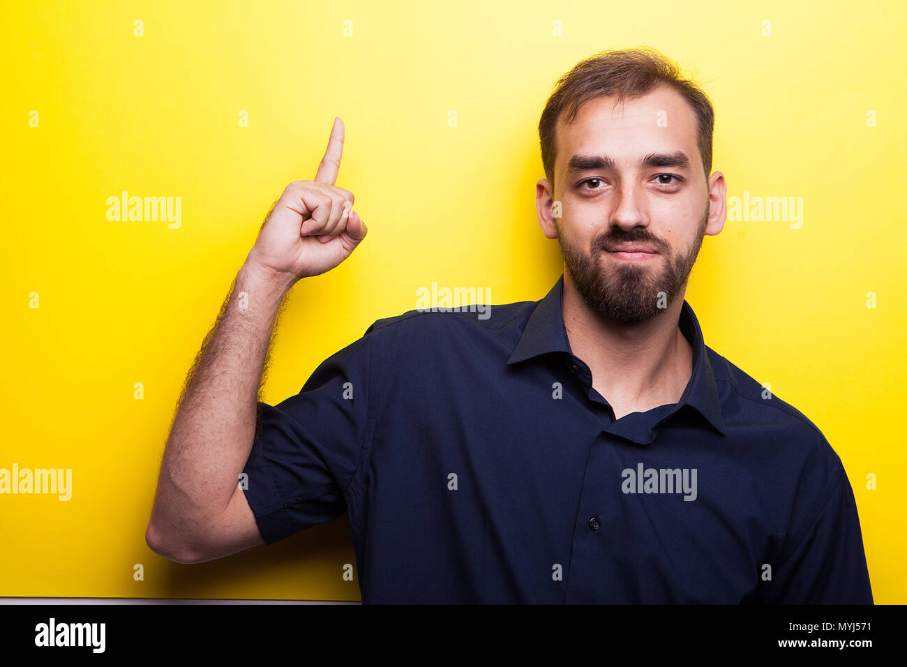 young attractive smart man showing hand signs pointing up Stock Photo ...