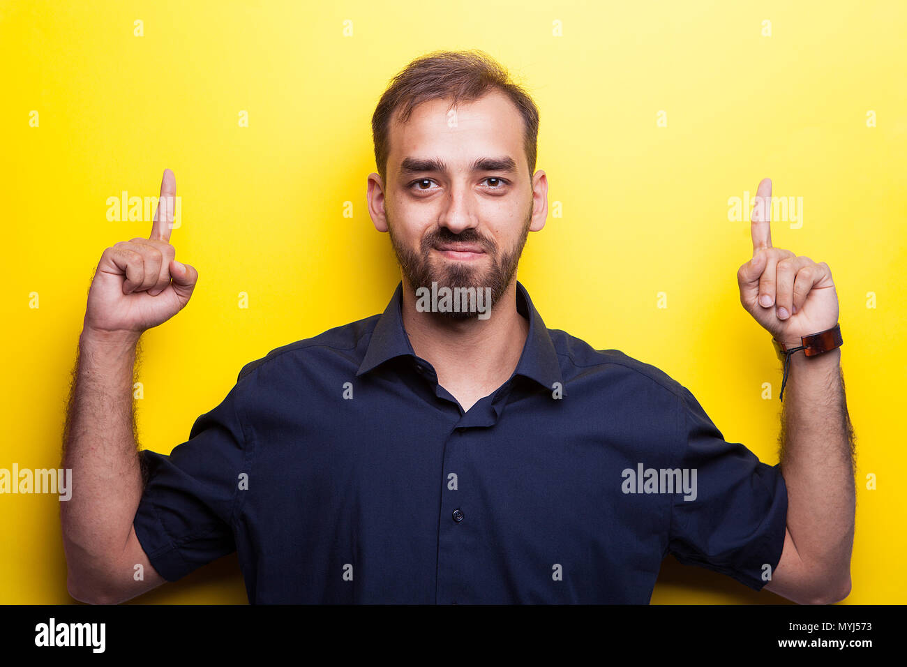 great looking young man pointing up Stock Photo - Alamy