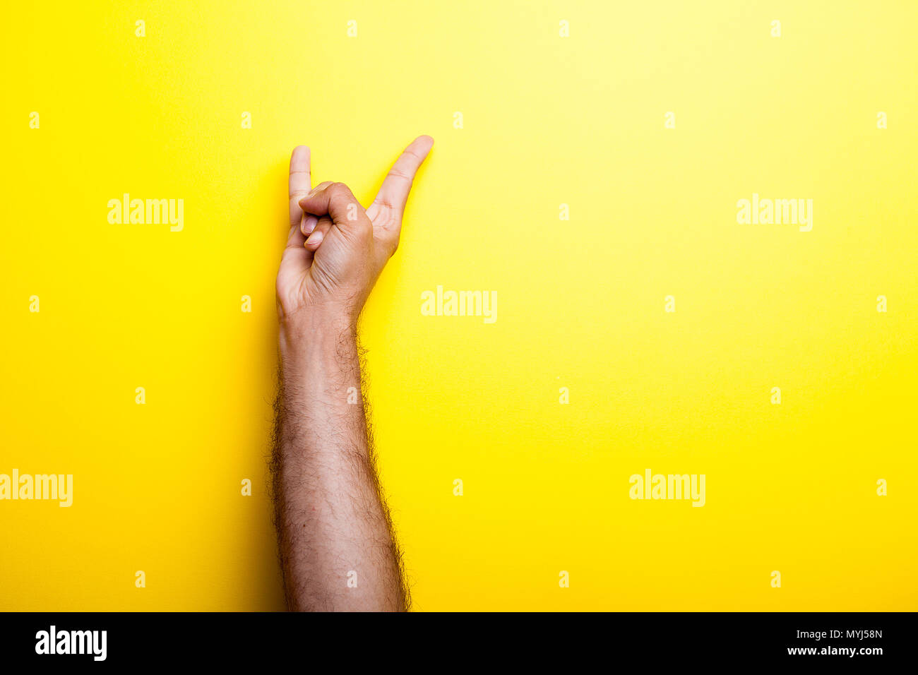Male hand showing the rock on sign Stock Photo - Alamy