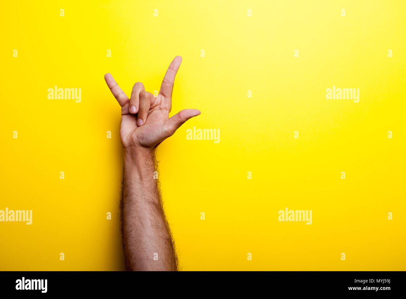 great looking young man having a blast with hand signs Stock Photo - Alamy