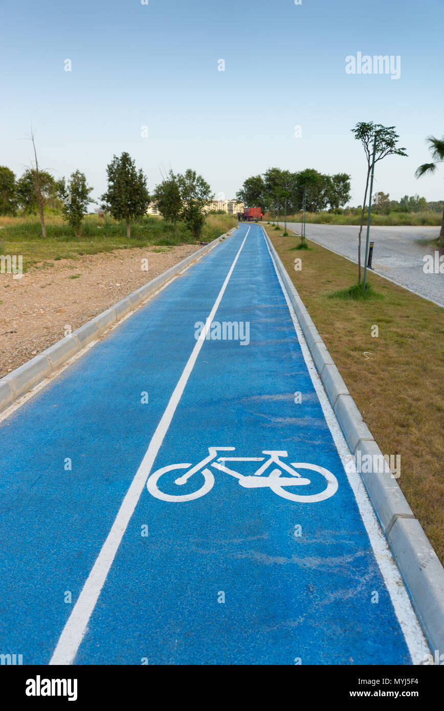 Bicycle icon painted on the asphalt surface of a rural cycling track ...