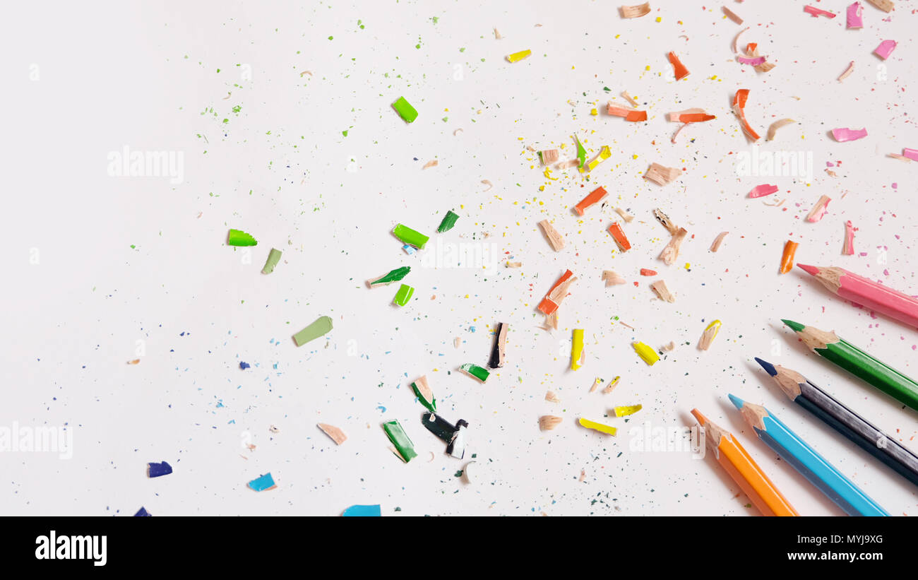 Flat lay of color pencils with colorful pencil shavings scattered ...
