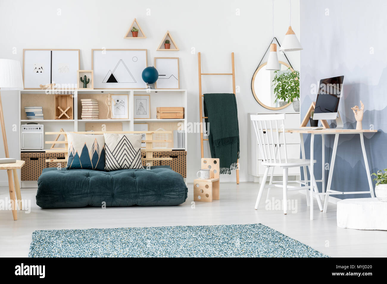 Green futon in teenager's room interior with white chair at desk with ...