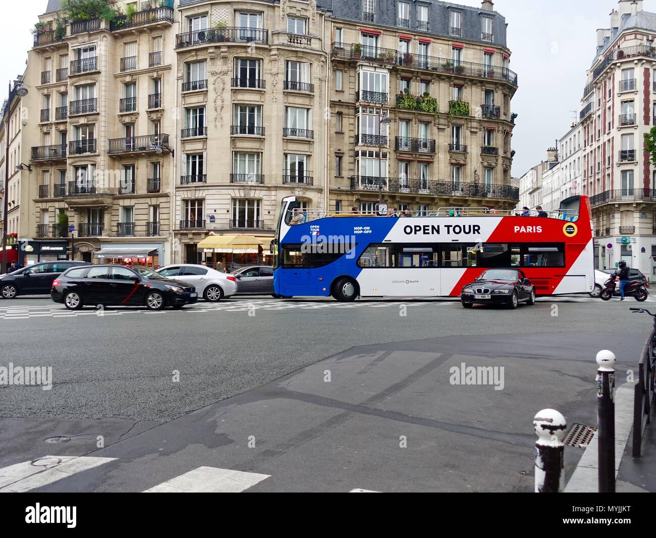Tourists on open top bus viewing city in a light rain, Montparnasse ...