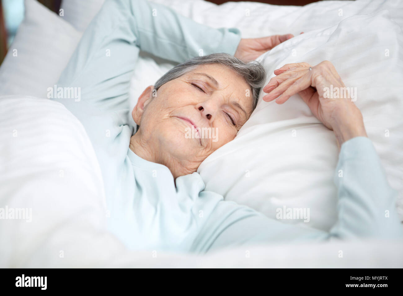 Mature elderly woman getting a good nights rest Stock Photo - Alamy