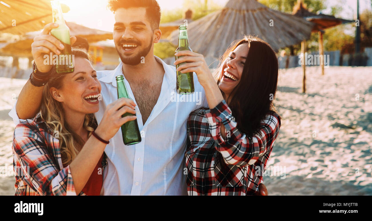 Group of happy friends partying on beach Stock Photo - Alamy