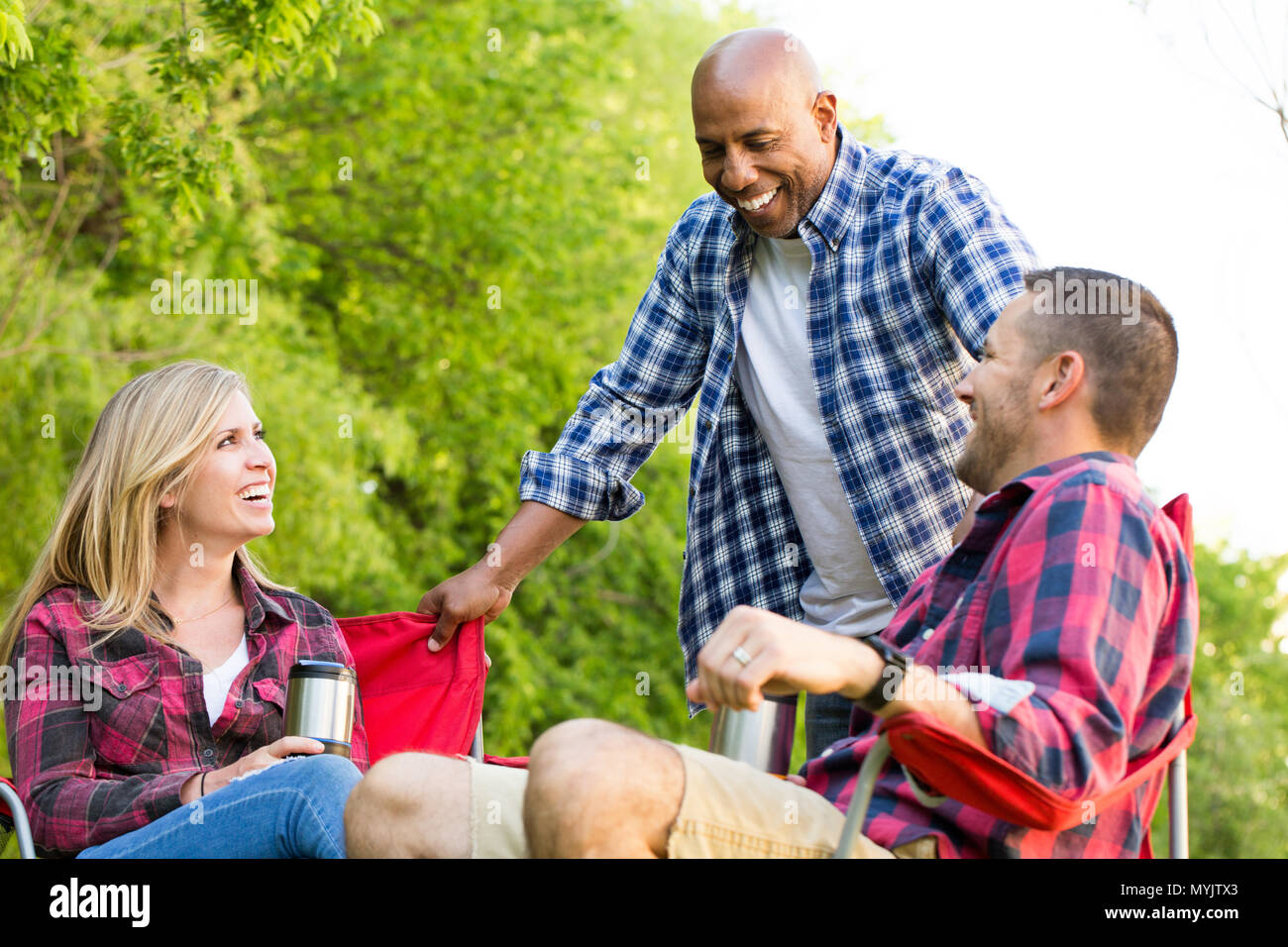 Diverse group of friends laughing and talking Stock Photo - Alamy