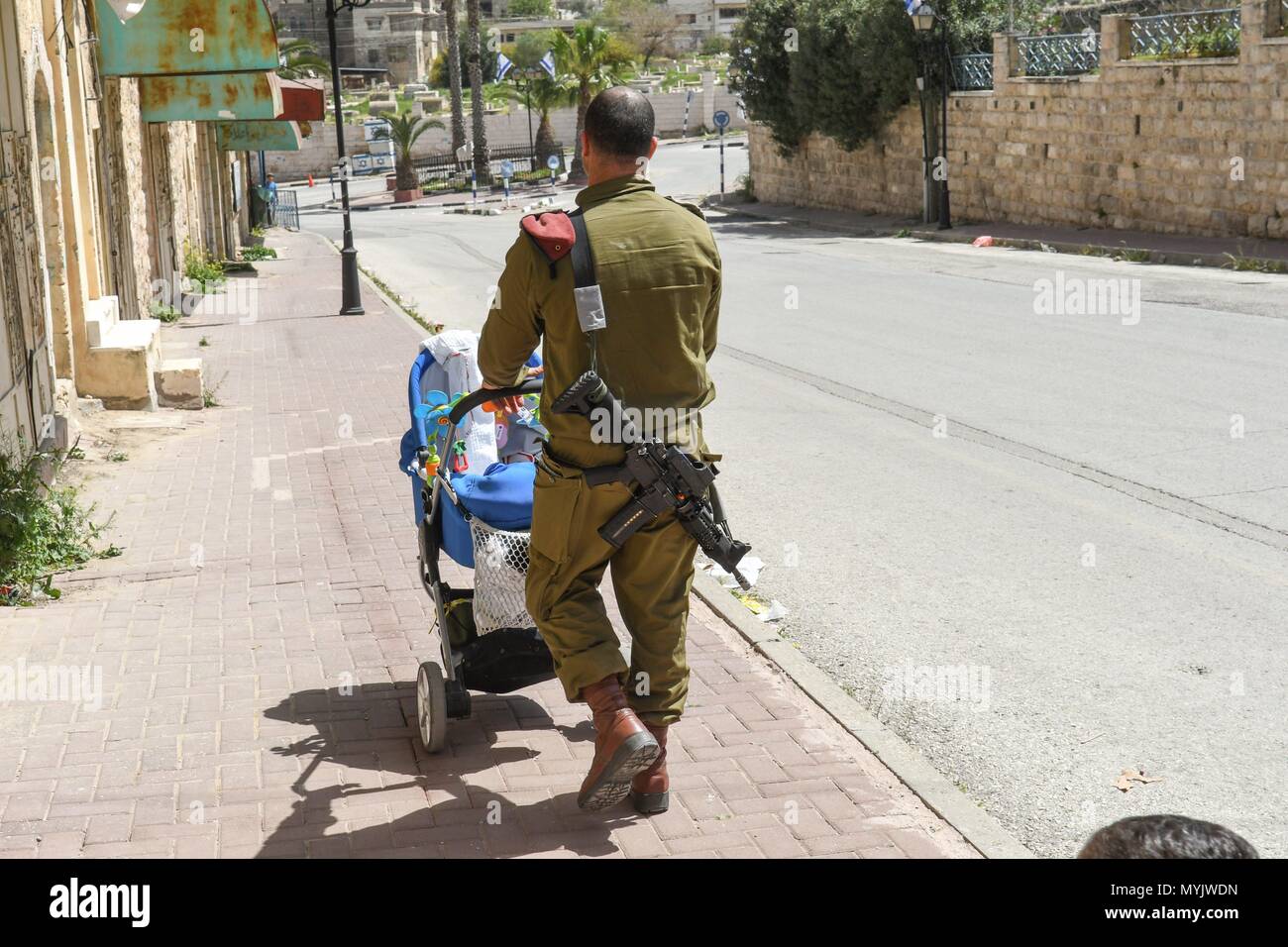 Israeli soldier with gun and buggy , Hebron, April 4, 2018 | usage ...