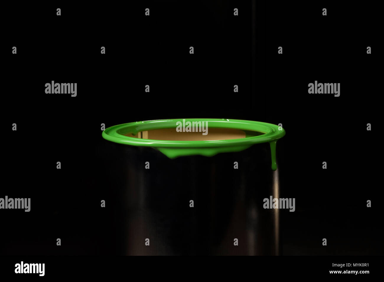 Colorful paint leaking down on wall of metal bucket. Isolated over ...