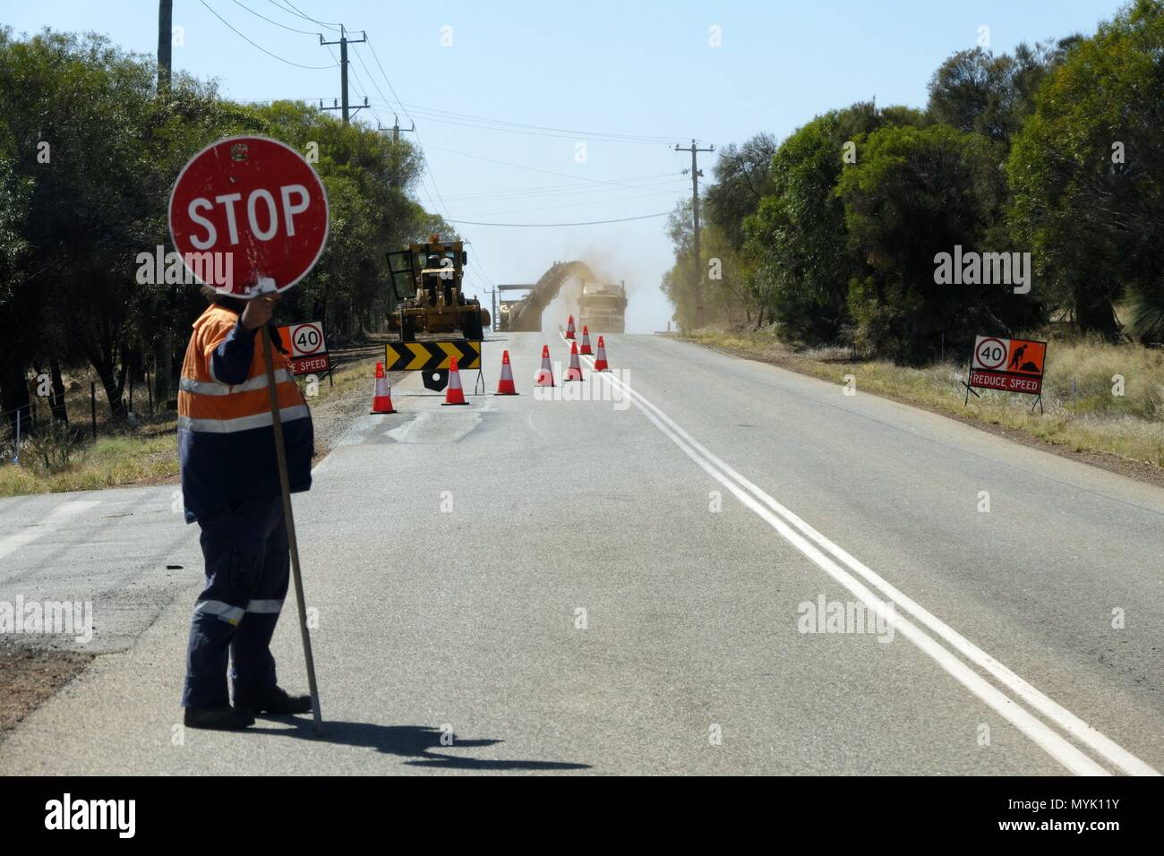 Road workman controlling traffic with a stop sign, Western Australia ...