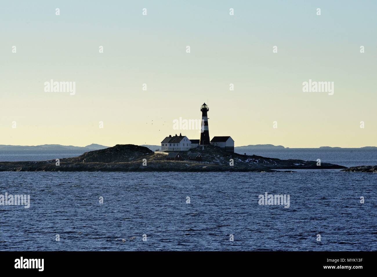 The small rocky island Landegode with a lighthouse and some buildings ...