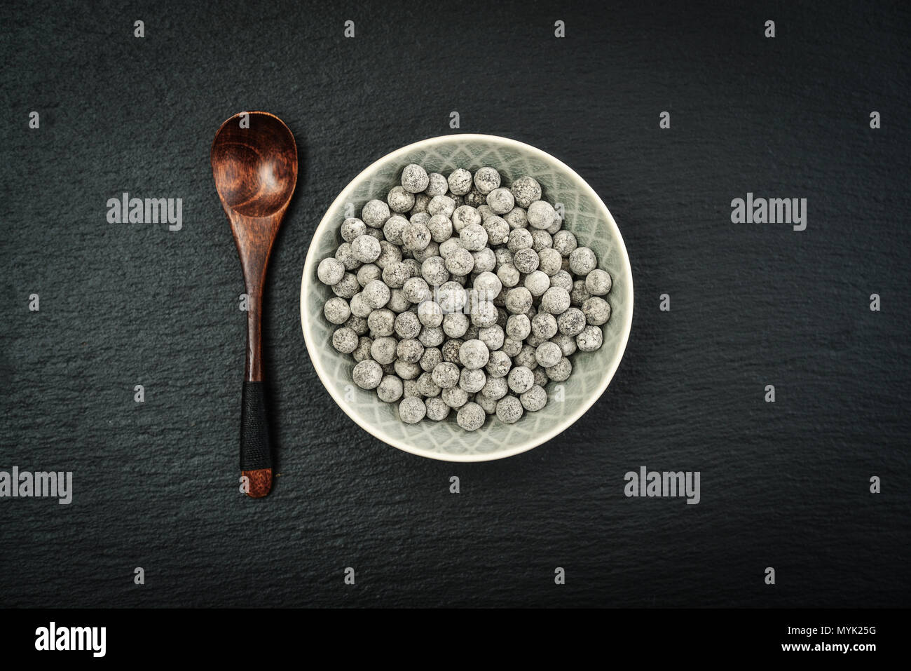Raw Tapioca Pearls in plate on black slate background. For Bubble tea ...