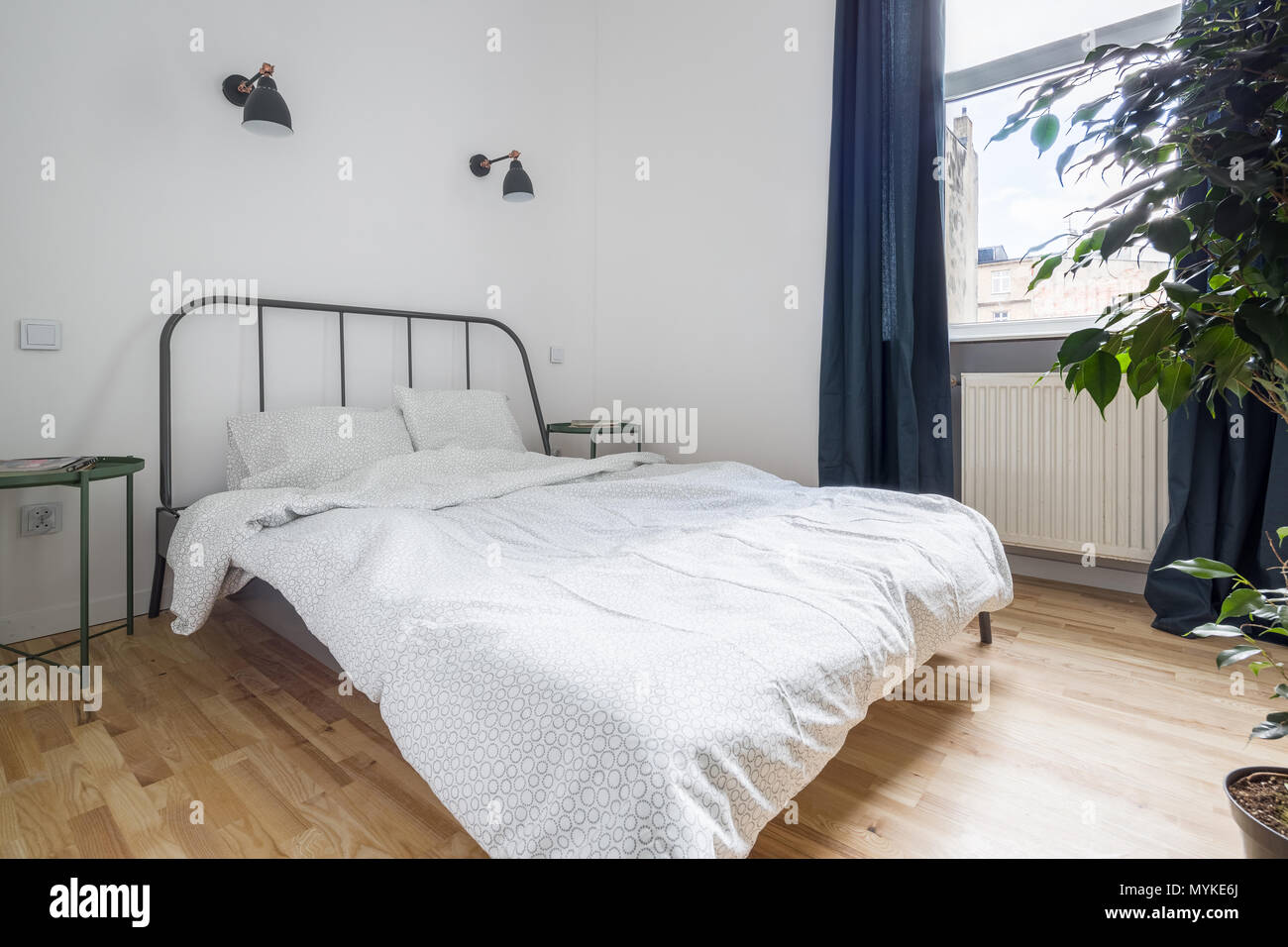 White bedroom with simple, double bed and window Stock Photo - Alamy