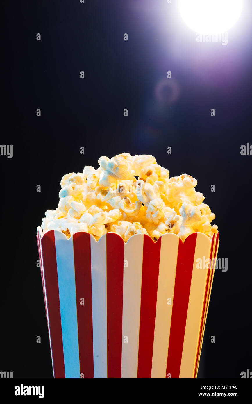 Popcorn over cinema light background, movie concept Stock Photo - Alamy