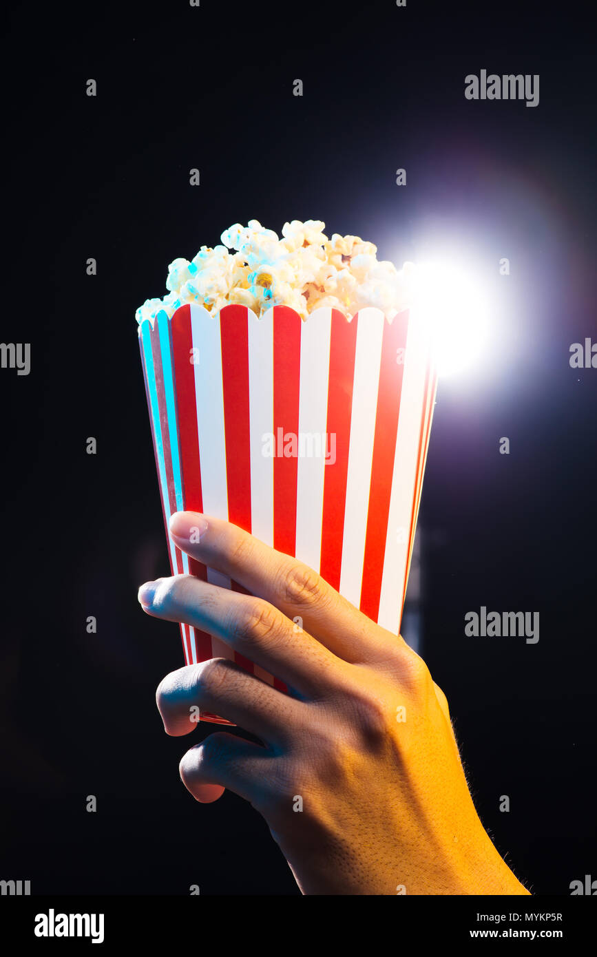 Popcorn over cinema light background, movie concept Stock Photo - Alamy