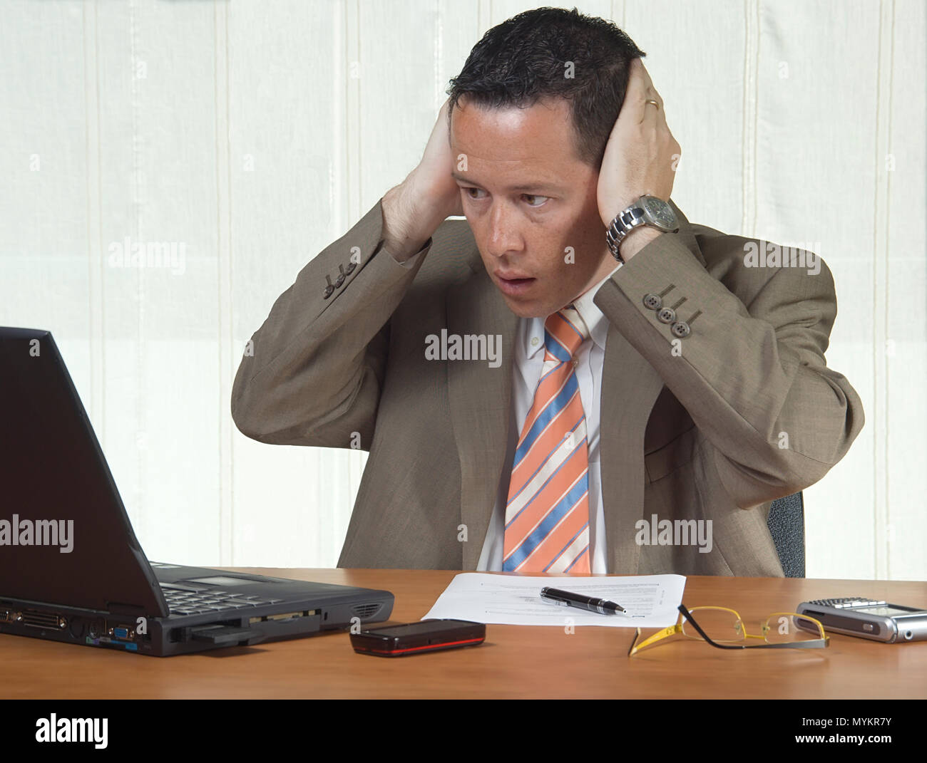 Worried businessman looking at his computer Stock Photo - Alamy