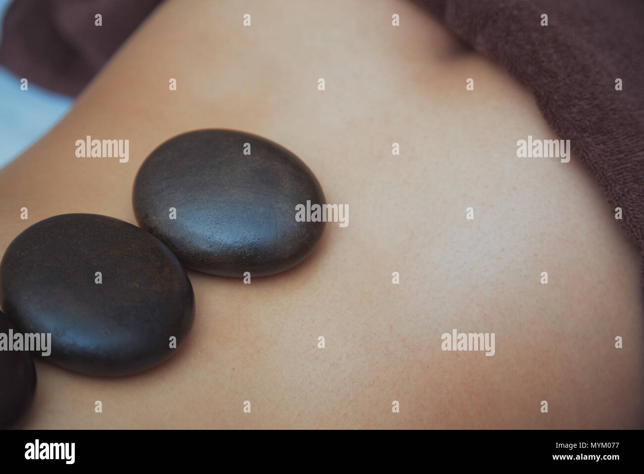 Back of woman laying in spa center Stock Photo - Alamy
