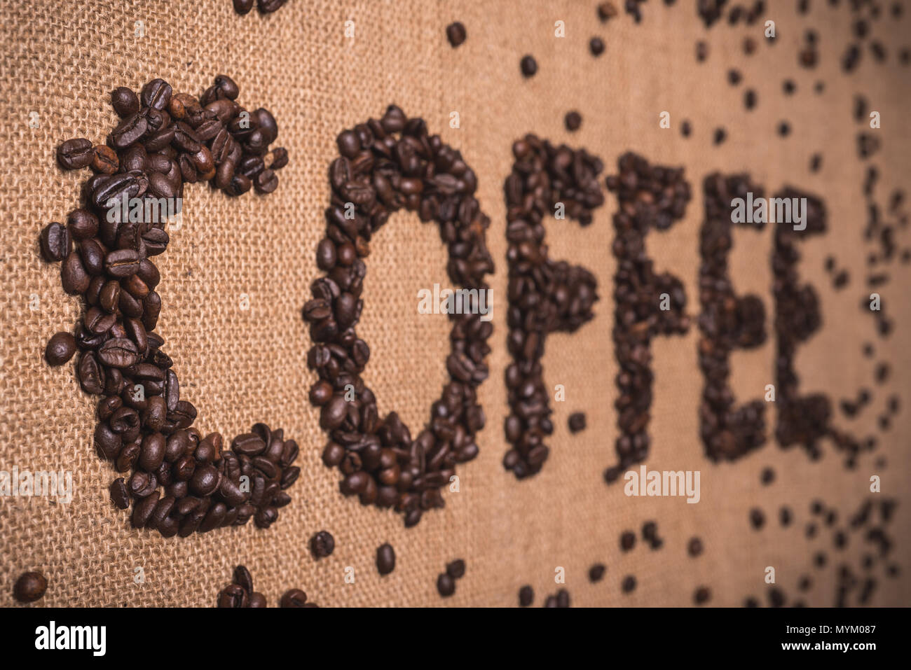 coffee word written with toasted coffee beans on top view composition ...