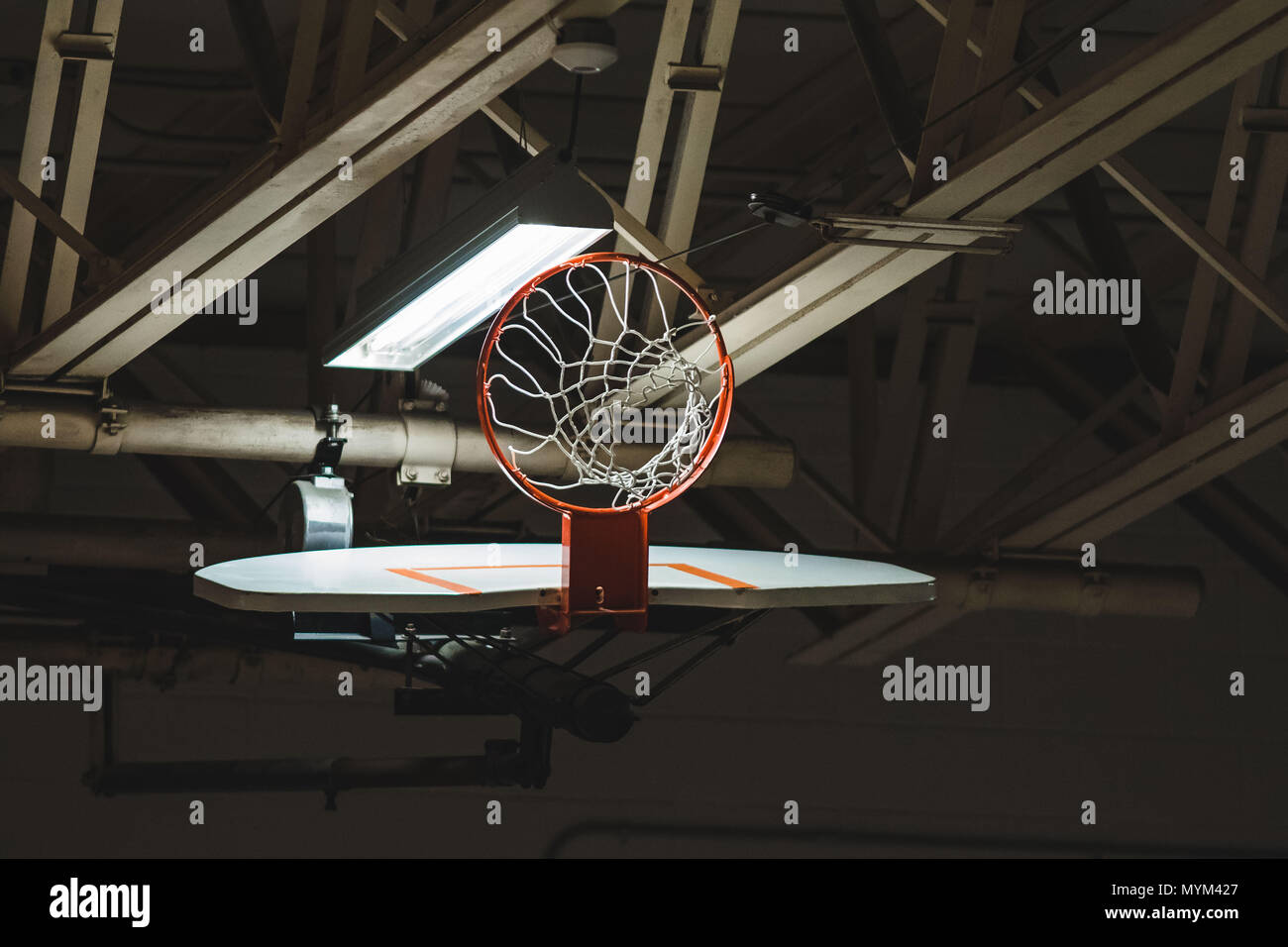 a basketball backboard hoop and net retracted up for storage Stock ...
