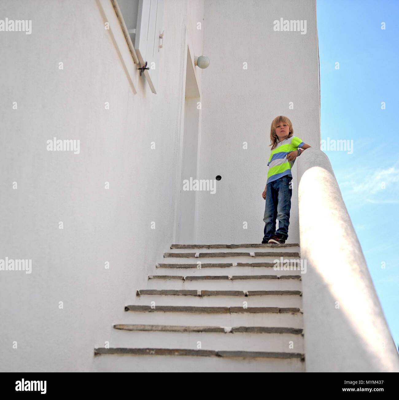 Portrait of little boy standing outside the house Stock Photo - Alamy