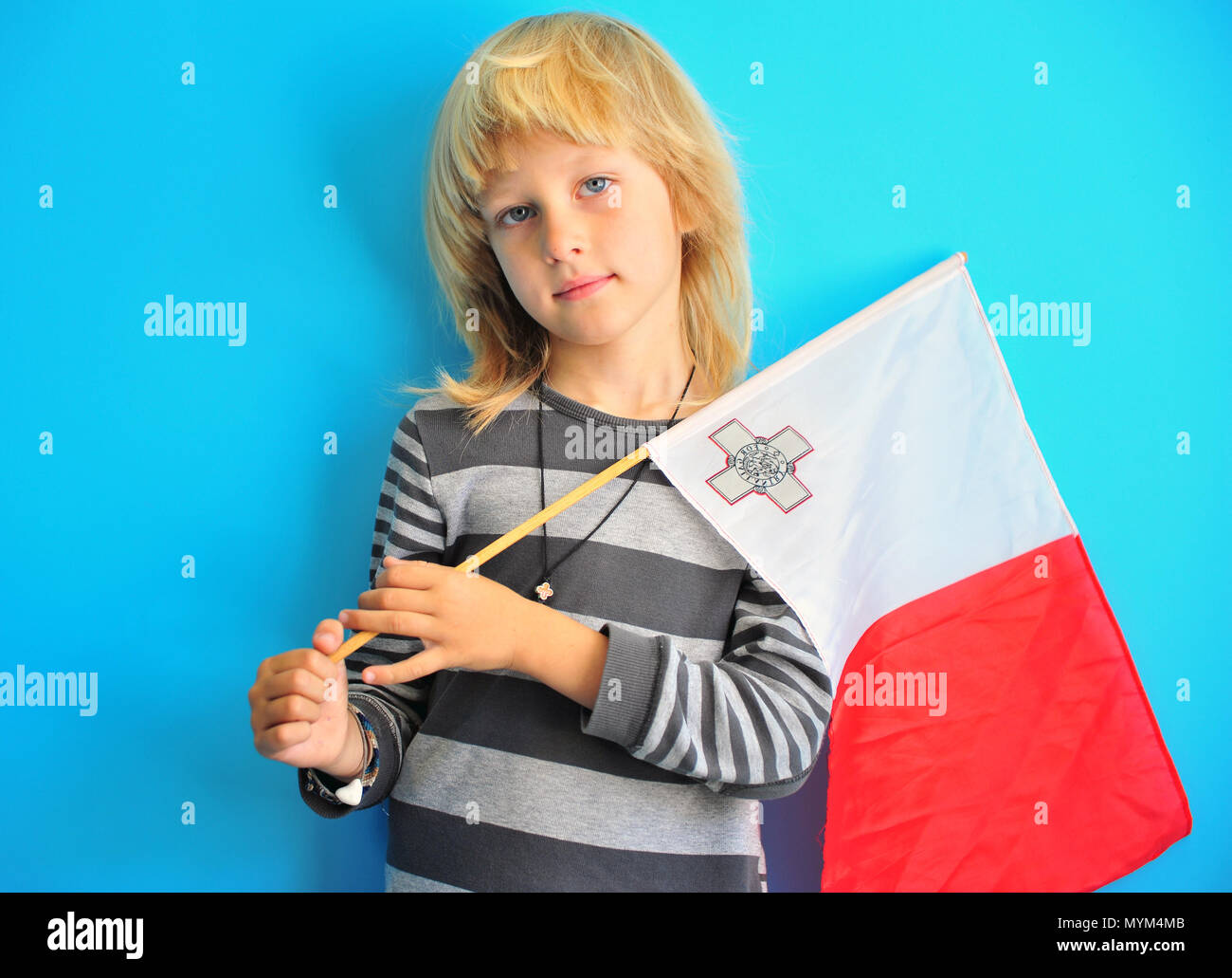 Little boy with flag of Malta on blue background Stock Photo - Alamy