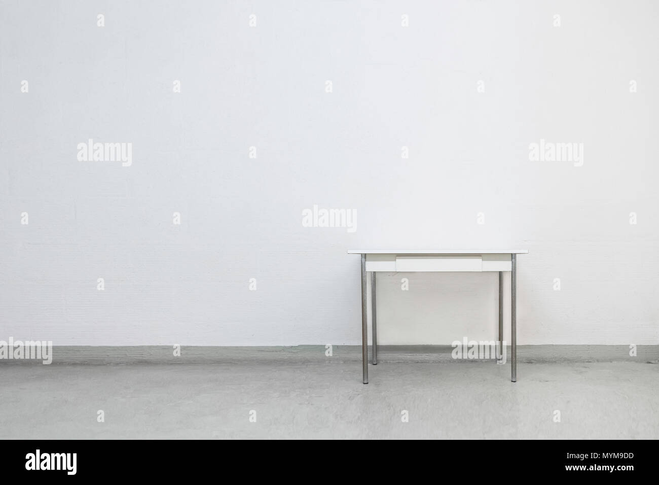 Isolated table against white wall Stock Photo - Alamy