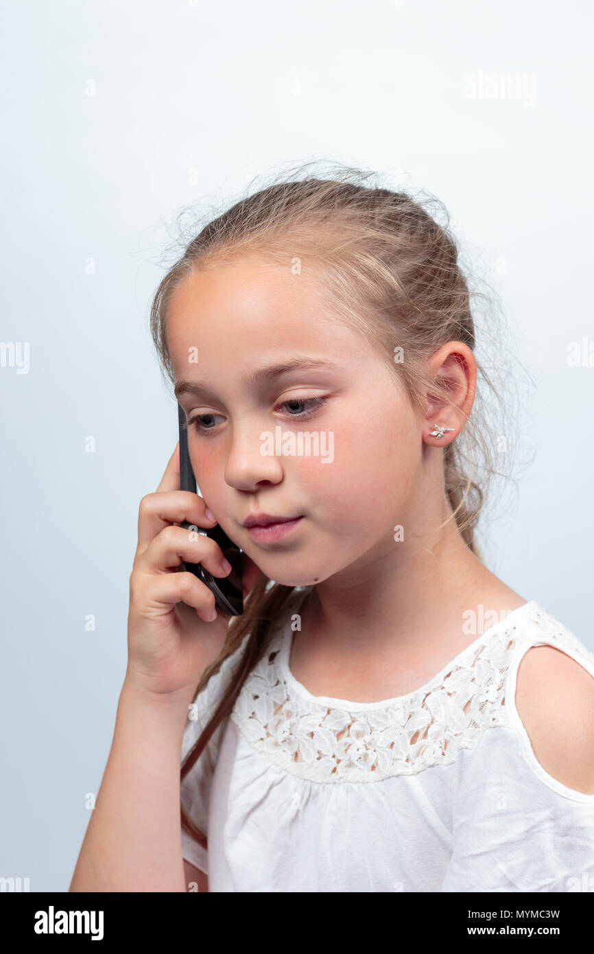 A portrait of a pretty young caucasian girl (10 years old) wearing a ...