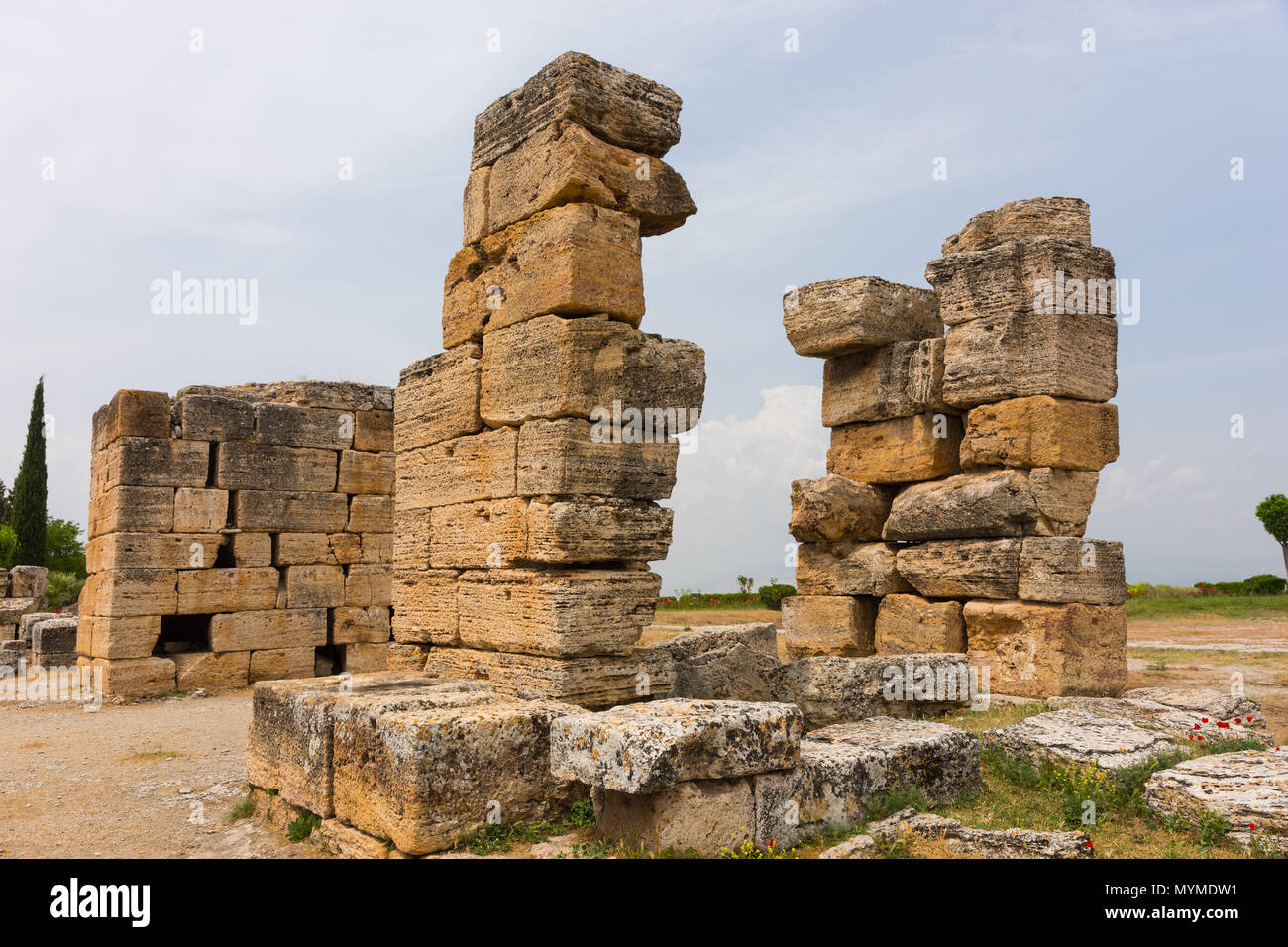 Remnants of ancient ruined walls with stone blocks close up against the ...
