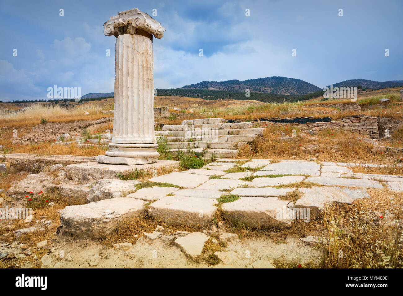 Classical ruins in mountainous Greek countryside with large paving ...