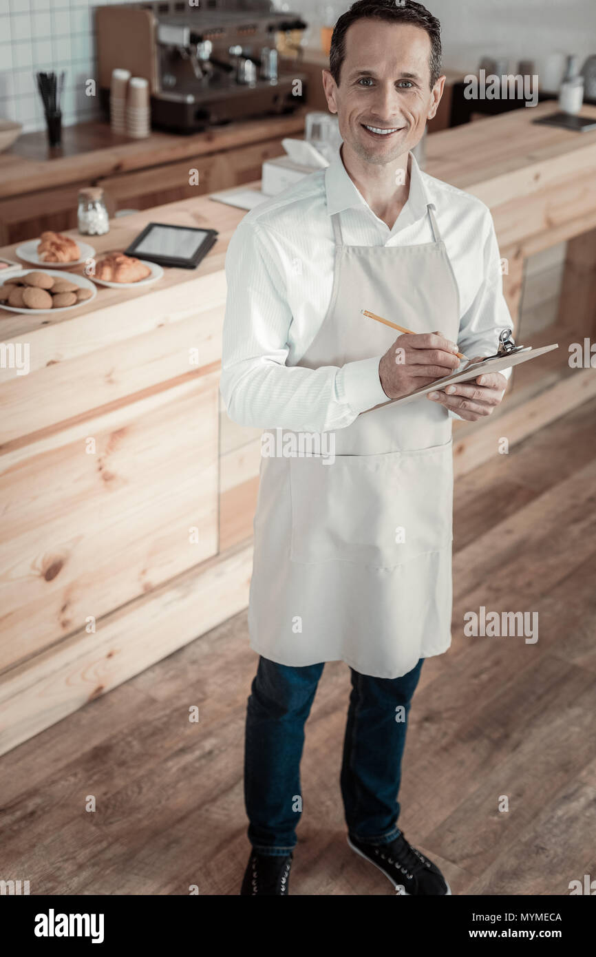 Positive delighted waiter taking order Stock Photo - Alamy