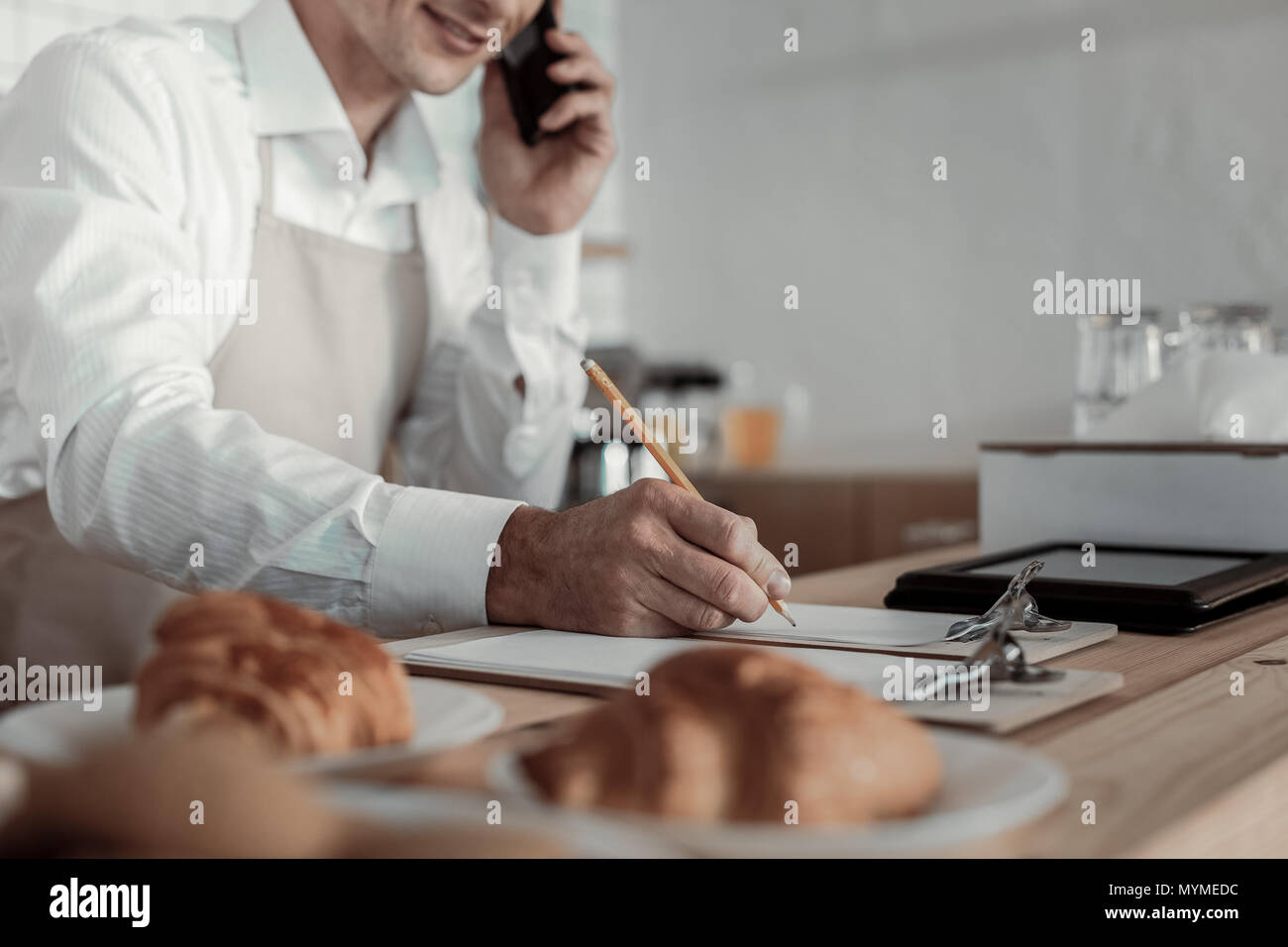 Competent businessman taking order per telephone Stock Photo - Alamy