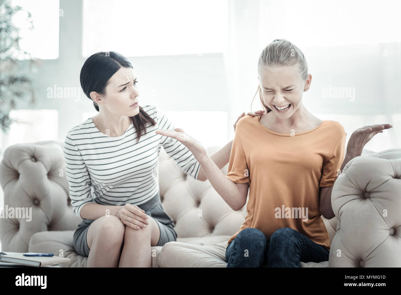 Irritated teen girl screaming during therapy Stock Photo - Alamy