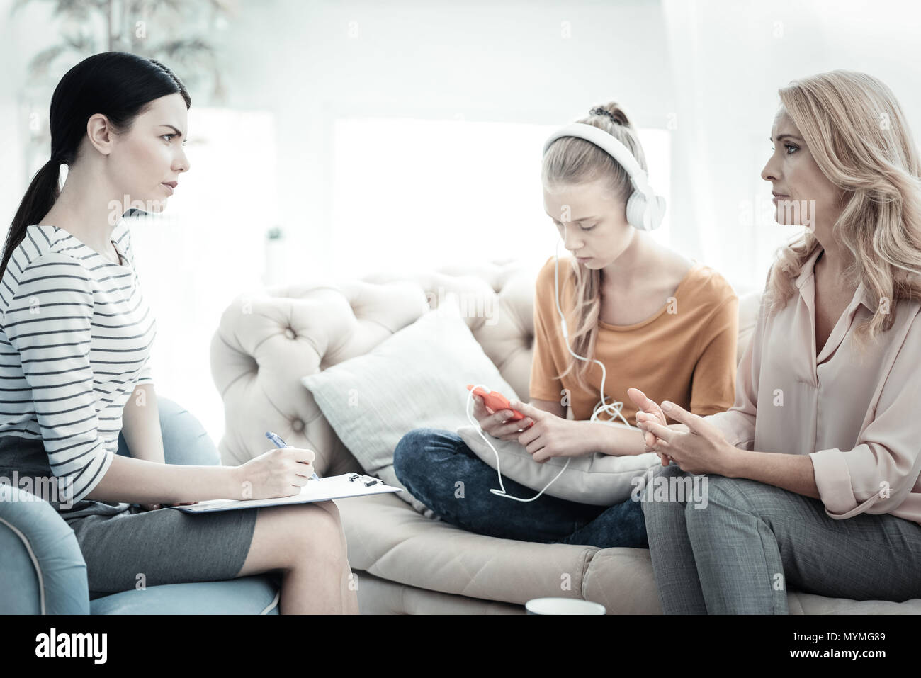 Worried mom and daughter visiting psychologist Stock Photo - Alamy