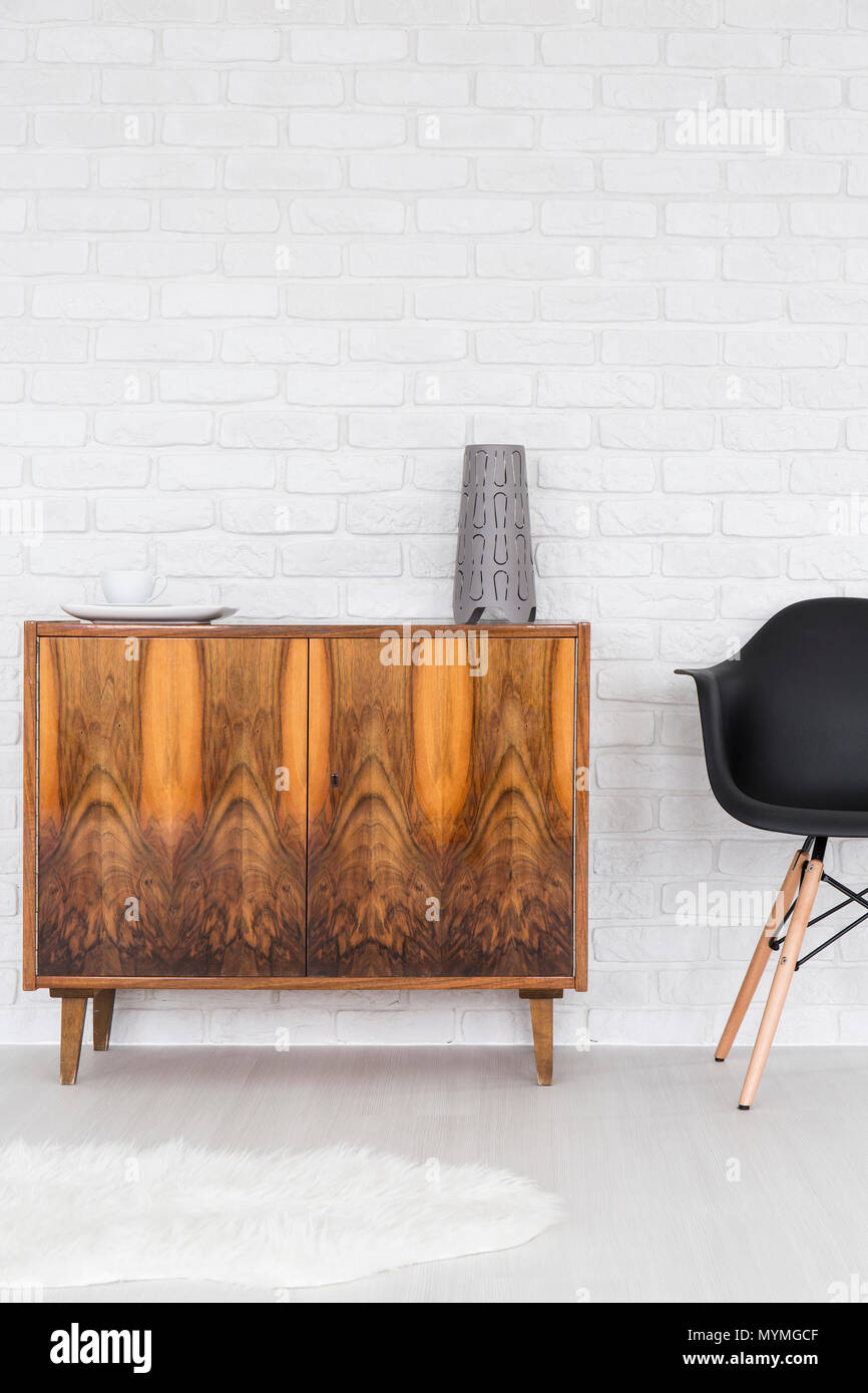 Loft arrangement- lacquered wooden commode on legs Stock Photo - Alamy