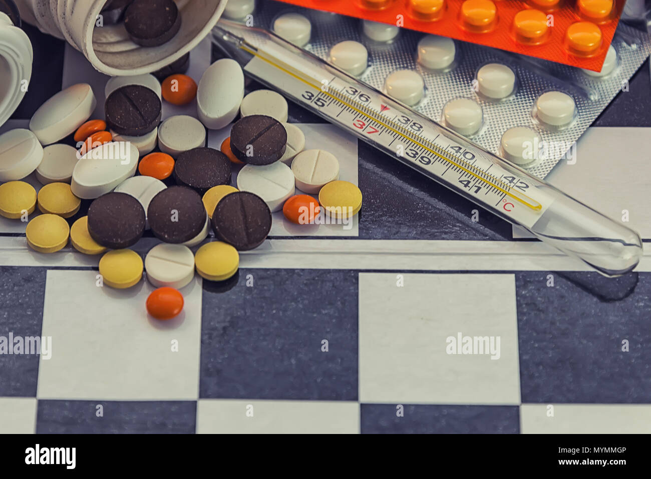 medicines are scattered on a sheet of paper, tablets in packages, means ...