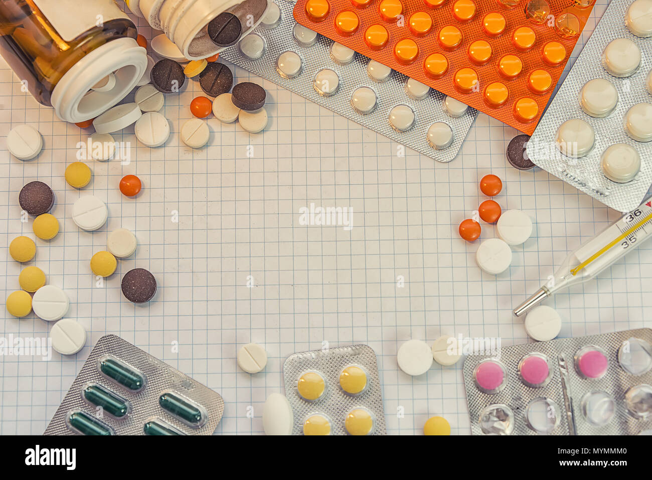 medicines are scattered on a sheet of paper, tablets in packages, means ...