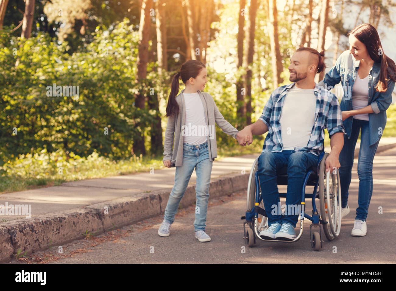 Pleasant nice family having a walk Stock Photo - Alamy