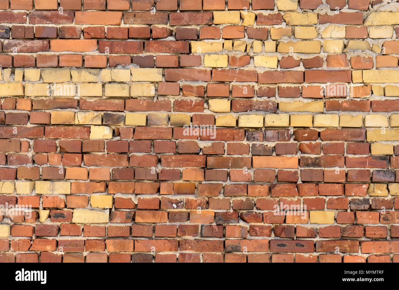 Wall with red and yellow bricks Stock Photo - Alamy