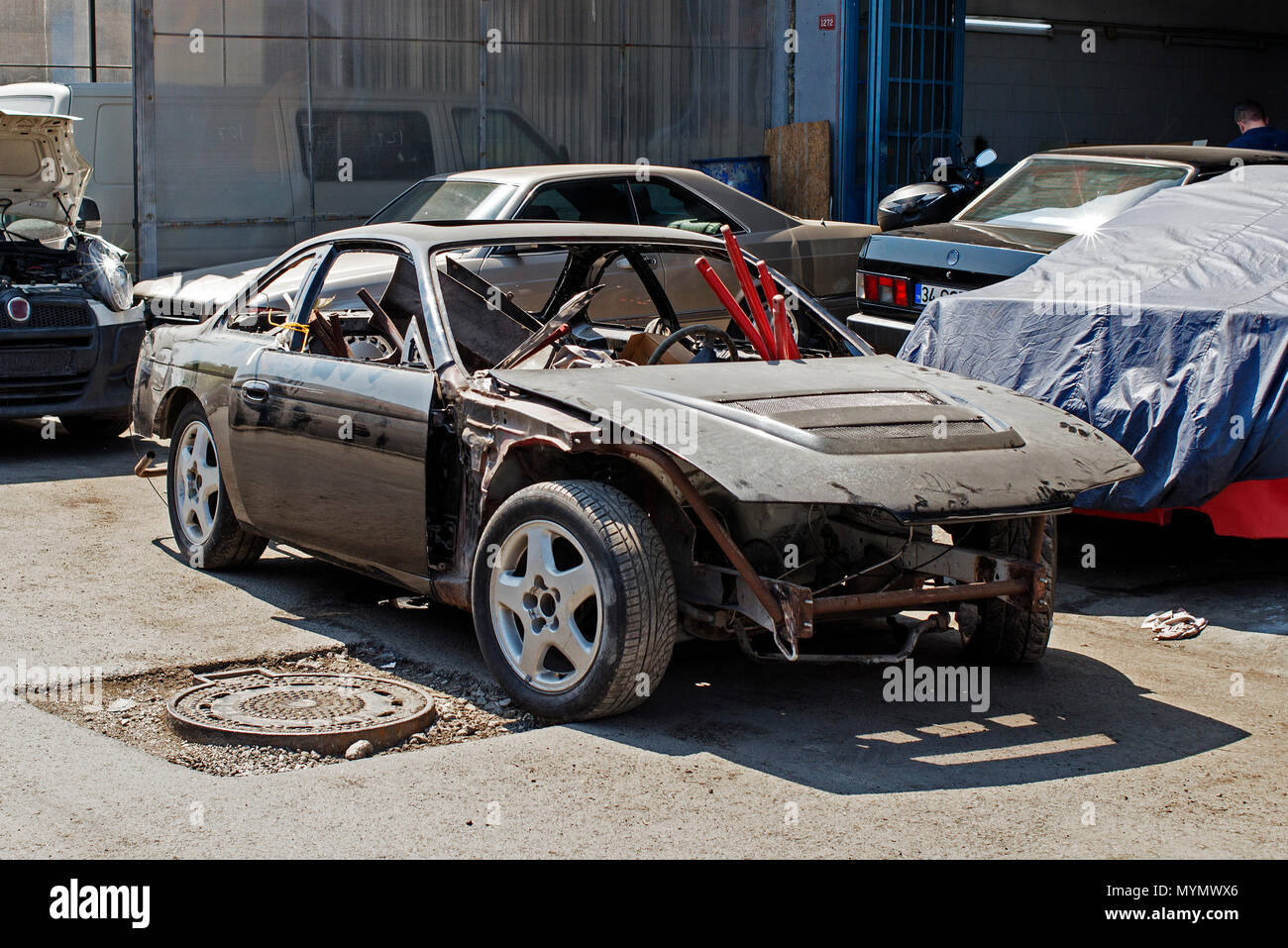A crashed car in a repair shop in the street Stock Photo - Alamy