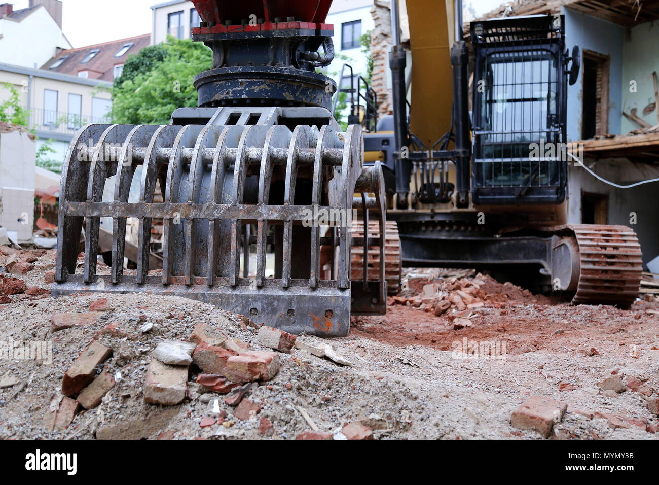A Demolition of a house with big machine Stock Photo - Alamy