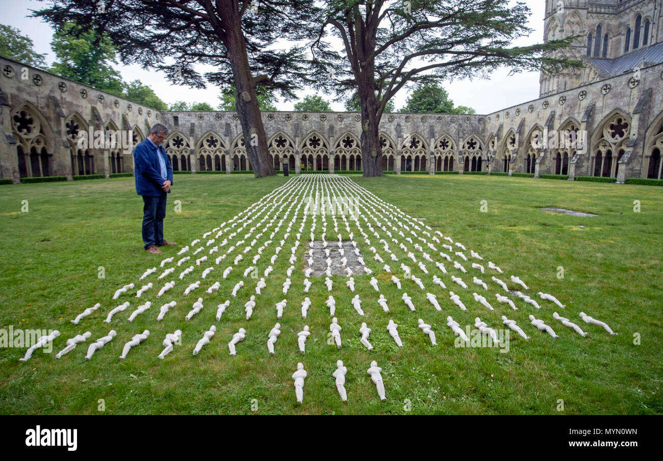 A visitor looks at 1,561 shrouded figures which are being installed in ...